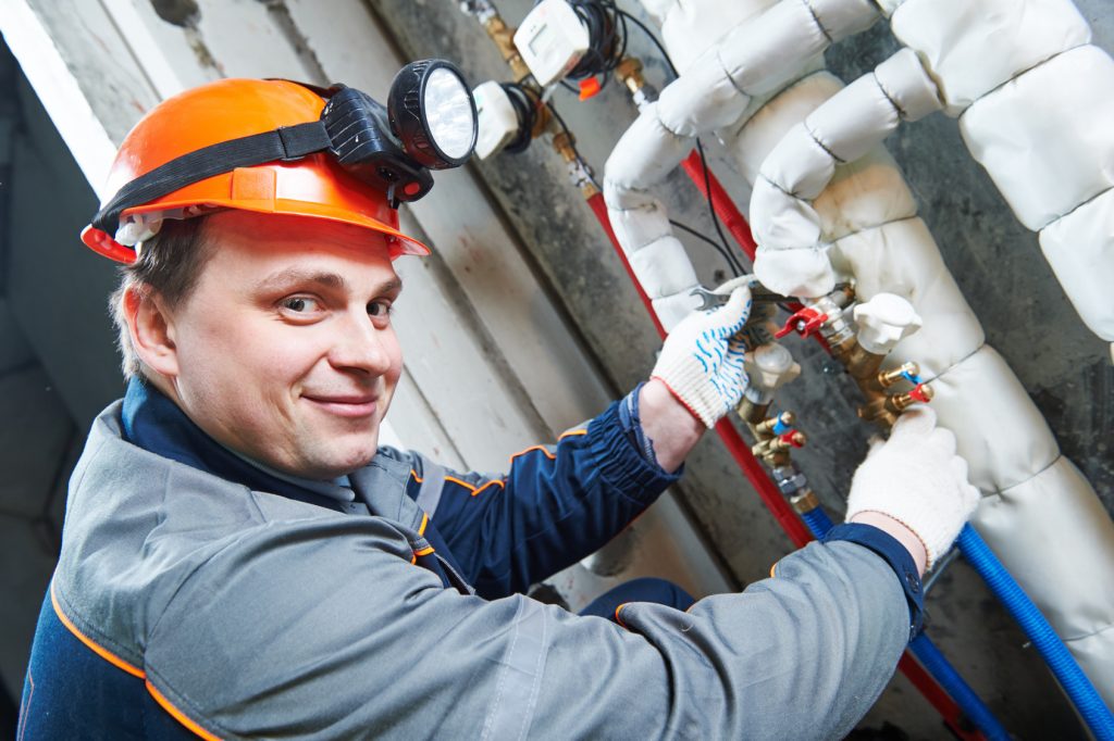 Plumber technician works with water valve - IPlumber